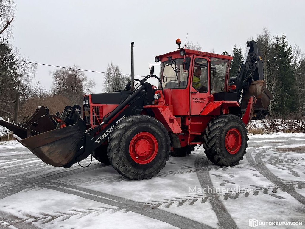 Prodaje se Volvo BM 6300, traktorikaivuri pyörittäjällä ja runsailla lisävarustei bager-utovarivač na aukciji