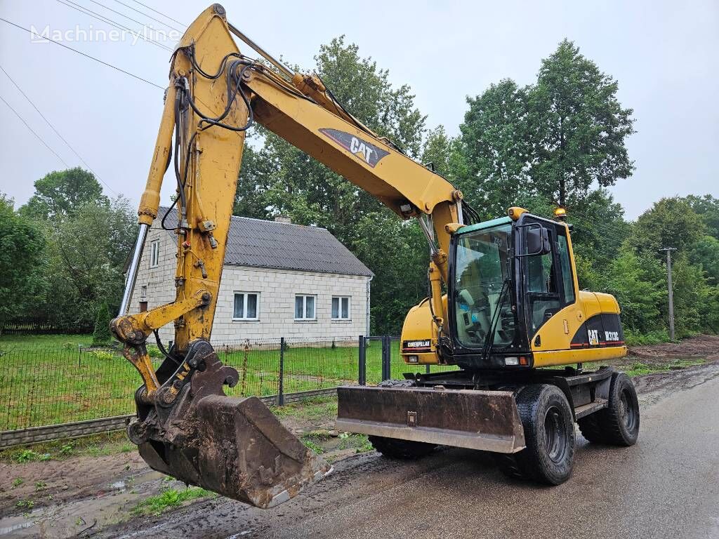 Caterpillar M 313 C bager točkaš