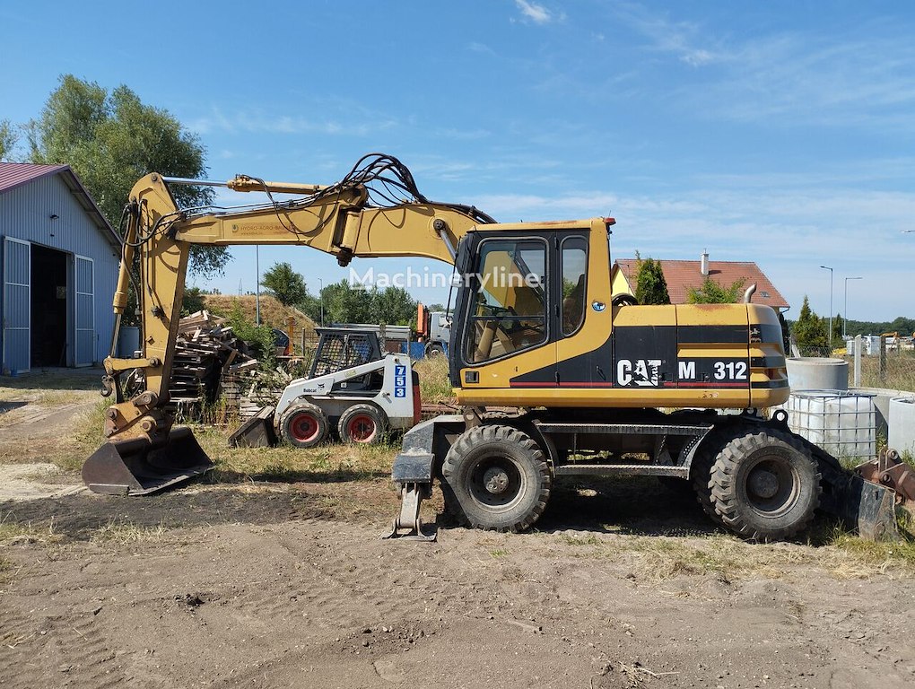 Caterpillar M312 bager točkaš