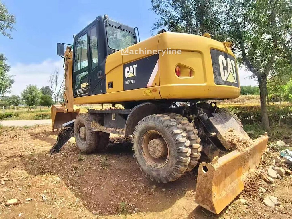Caterpillar M317 bager točkaš