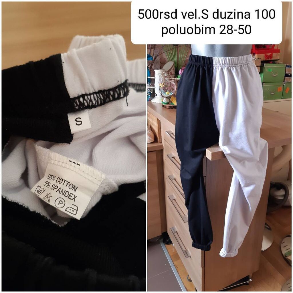 Dukser pantalone crno‑bele, model sa kontrastnim polovinama. -