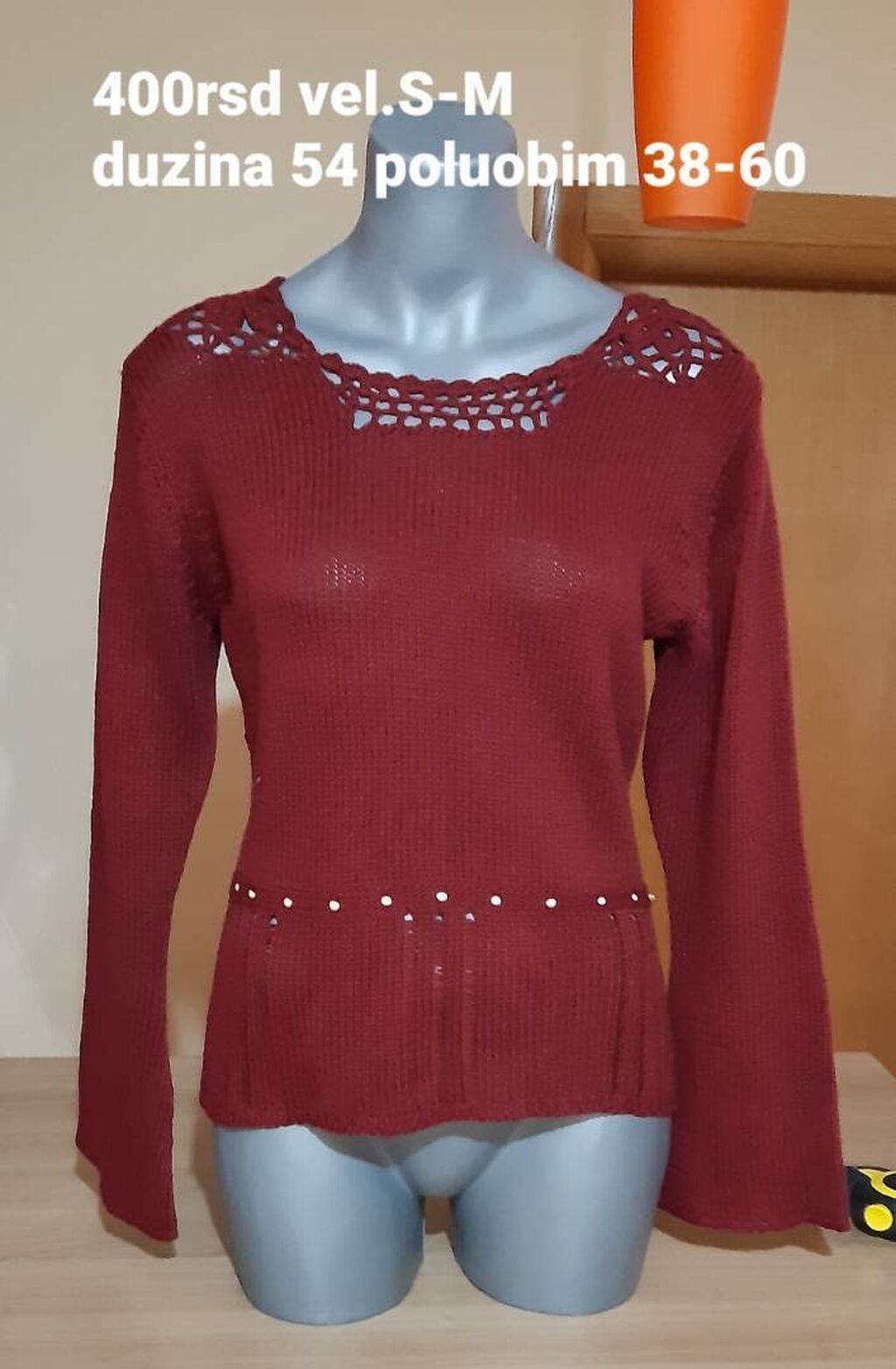 Pletena bordo bluza sa dugim rukavima i dekorativnim detaljima. -