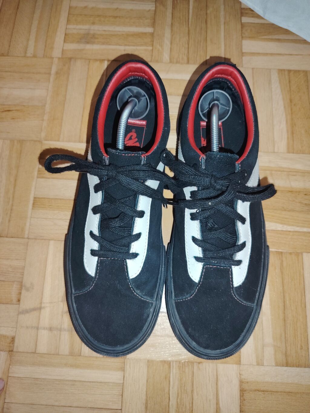 Crne skate patike sa belom talasastom prugom sa strane i crvenim