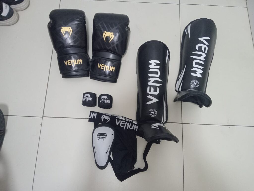 Venum boxing kit includes 14 oz black boxing gloves with gold and