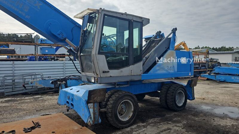 Fuchs MHL 340 z chwytakiem i elektromagnes bager za pretovar