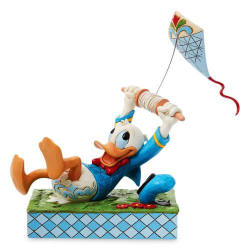 A FLYING DUCK (DONALD FLYING A KITE FIGURINE)