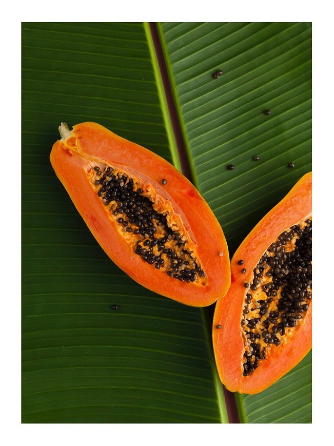 SLICED PAPAYA ON LEAF