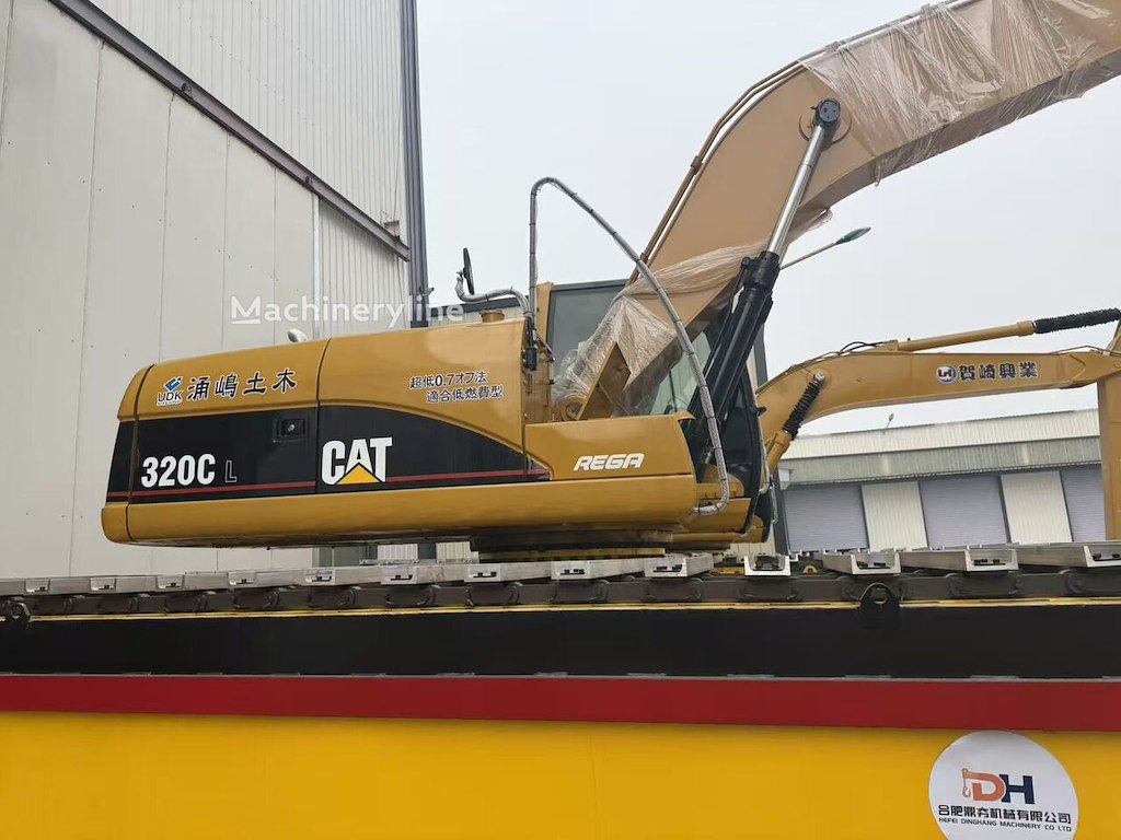 Caterpillar 320CL bager amfibija