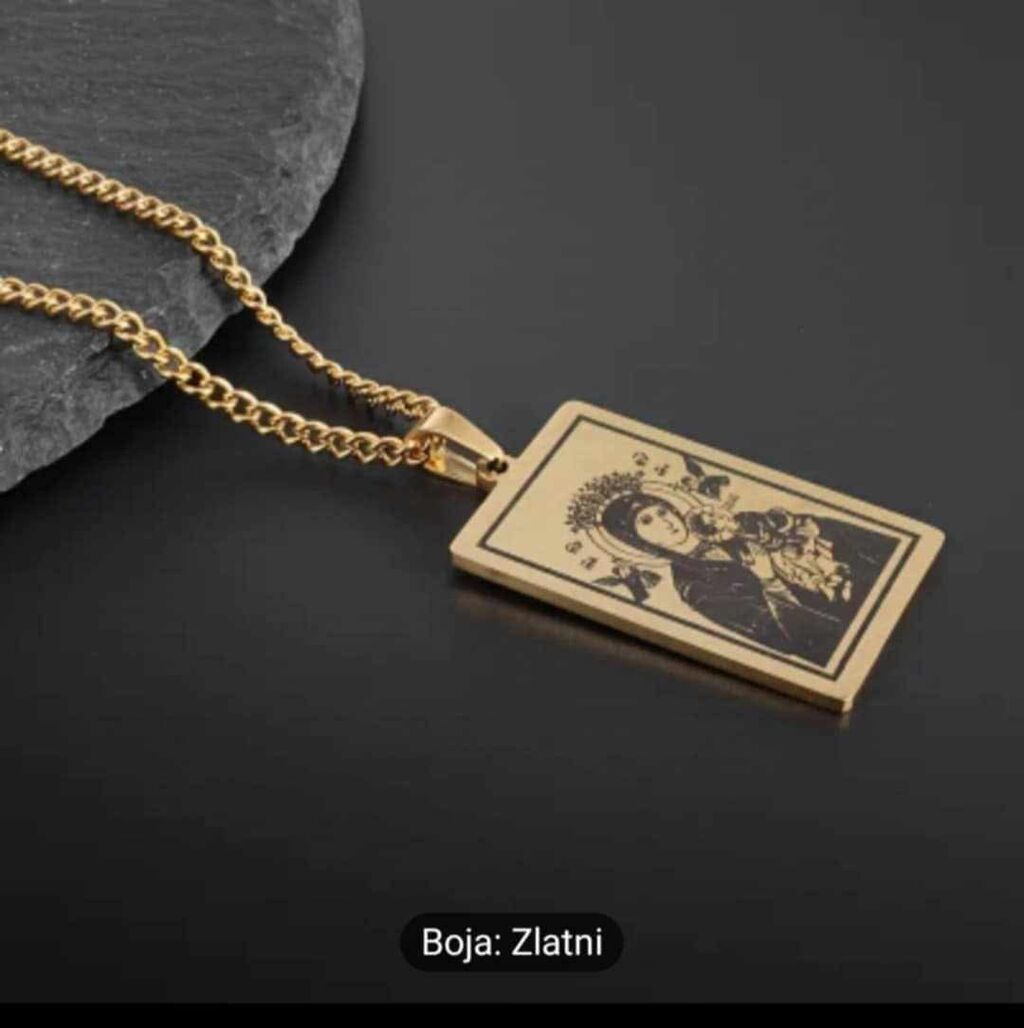 Zlatna ogrlica sa pravougaonim medaljonom sa religioznim motivom. -