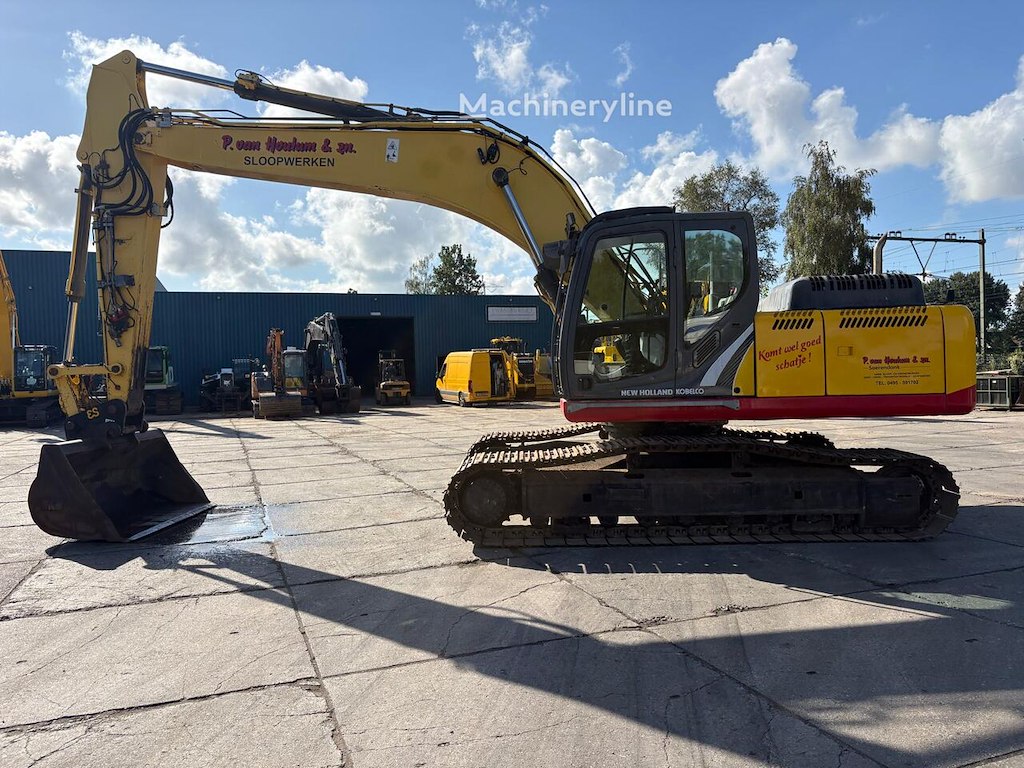 New Holland E265 C (Kobelco) bager guseničar