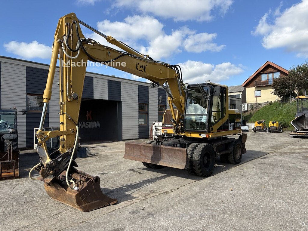 Caterpillar M312 bager točkaš